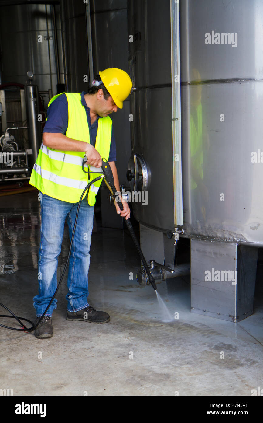 worker cleaning the floor with a pressure washer Stock Photo - Alamy