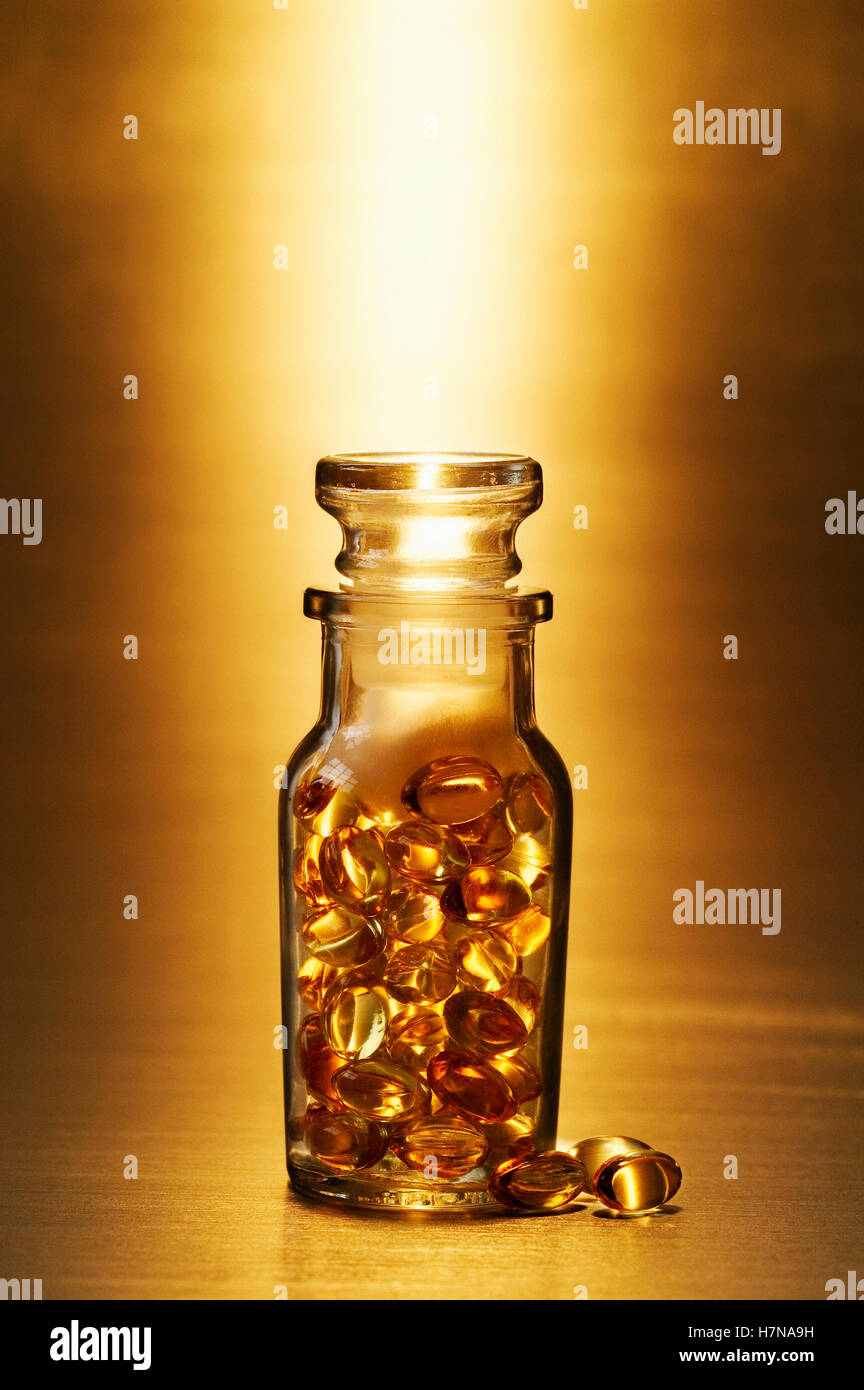 Glass medical beaker full of pills Stock Photo - Alamy