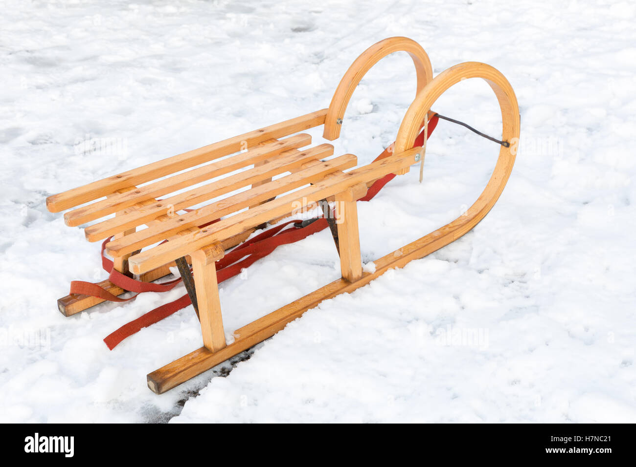 Wooden children sleigh in winter snow Stock Photo - Alamy