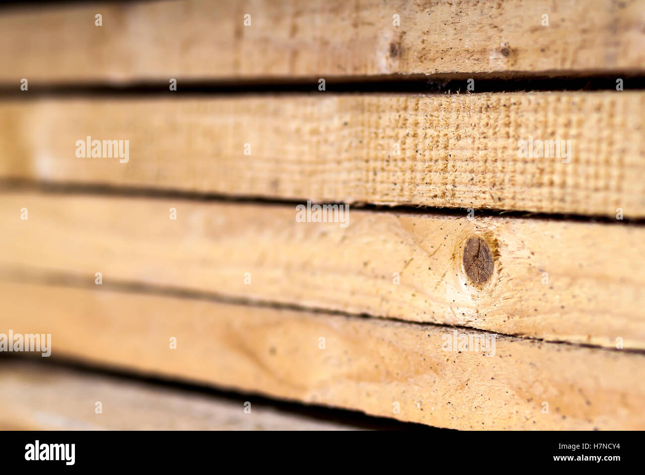 Stack of new wooden studs at the lumber yard. Wood timber construction ...