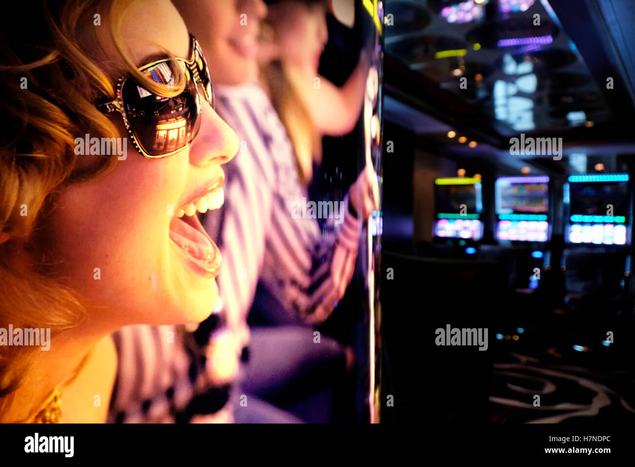 A poster depicting happy people next to slot machines also called fruit ...