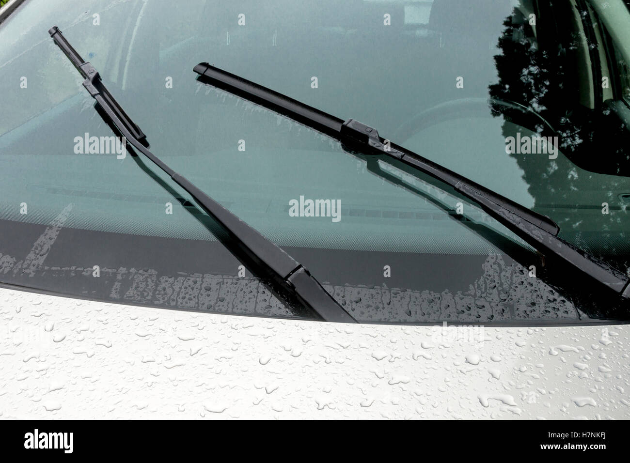 Close up of wet windshield reflections patterns textures and wiper ...