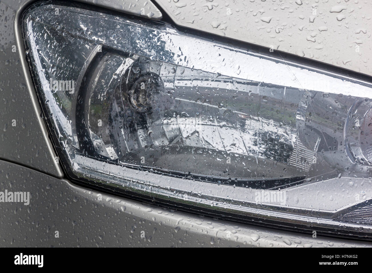 Close up of motor vehicle wet damp head lamp patterns textures ...