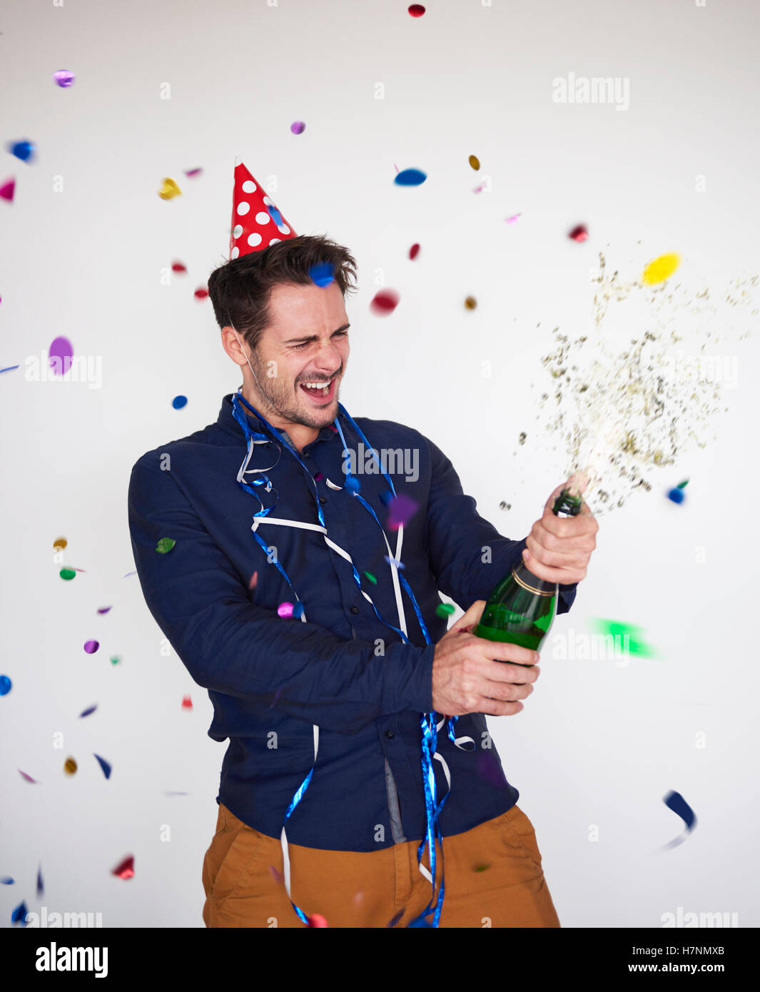 Man opening a bottle of champagne Stock Photo - Alamy
