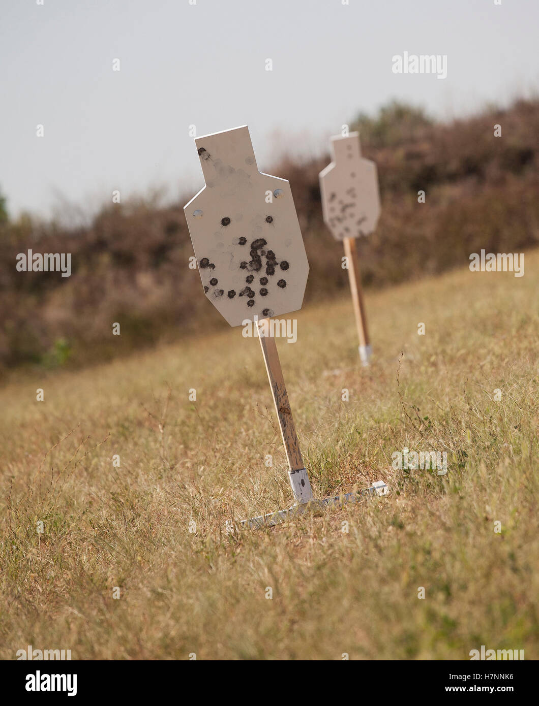 Steel targets painted white that have been shot during practice Stock ...