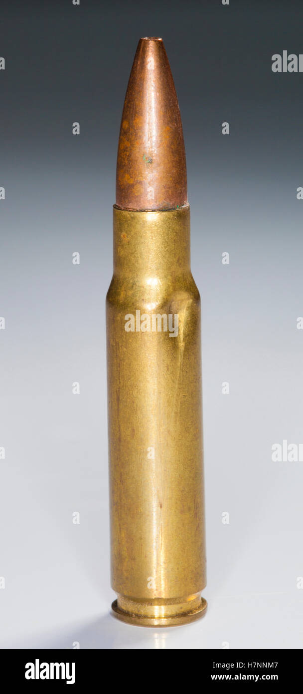 Center fire rifle cartridge with an unwanted crimp on a white ...