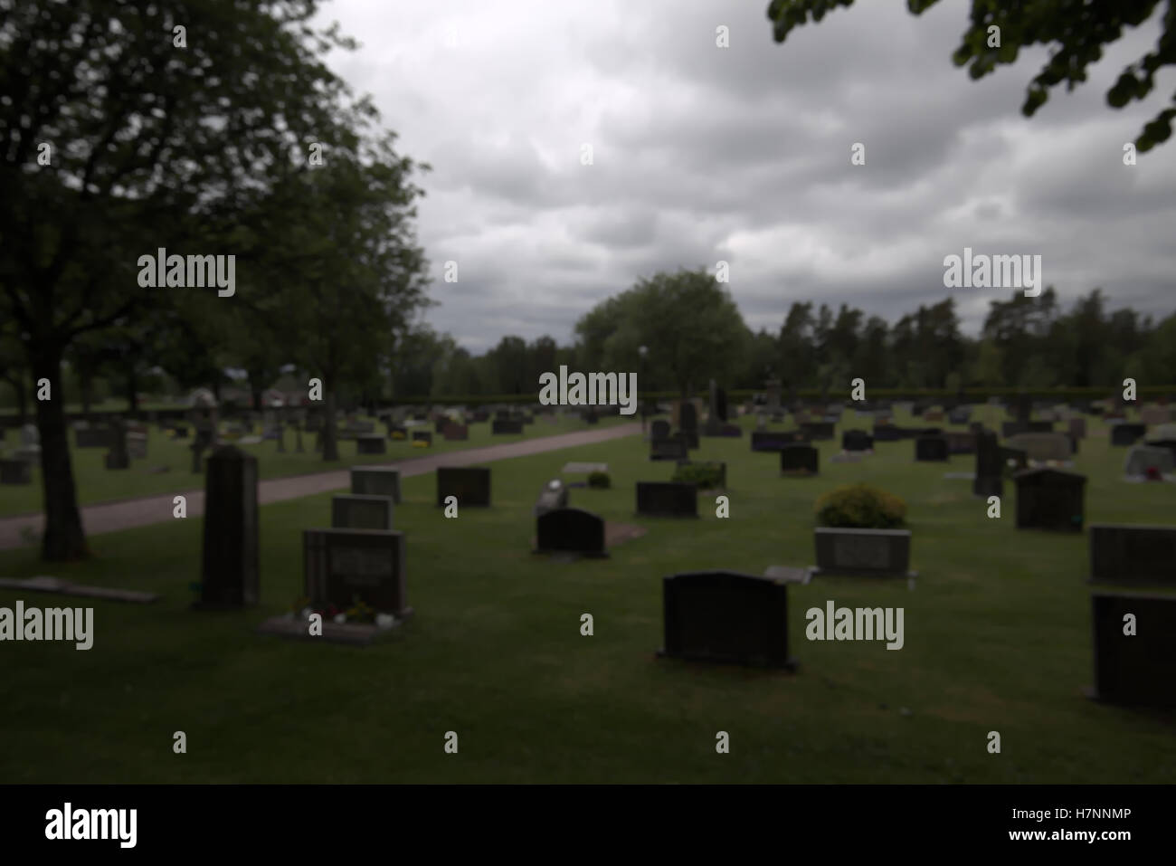 Blurred image of a dark and spooky cemetery Stock Photo - Alamy