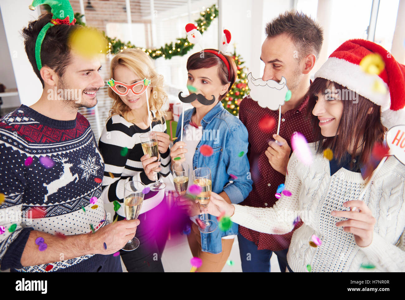 Cheerful group of young people at Christmas celebration Stock Photo - Alamy