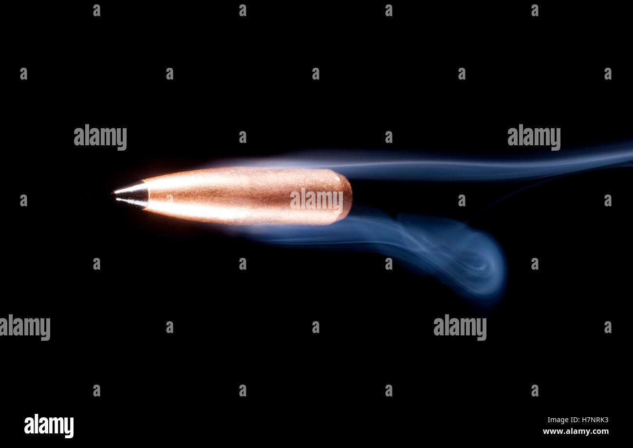 Copper coated bullet with polymer tip that looks like it is flying ...