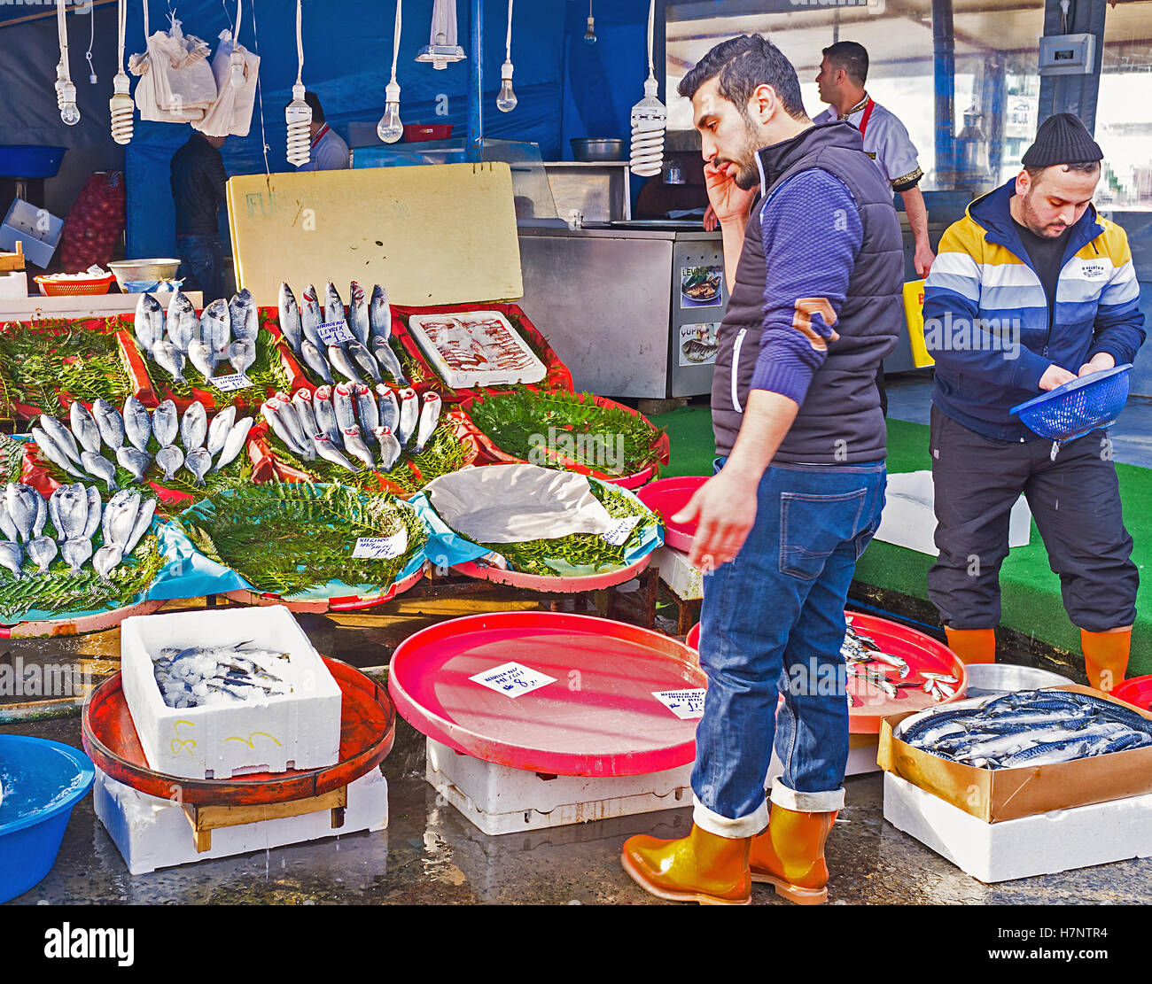 The central fish market next to Galata bridge is always busy and ...