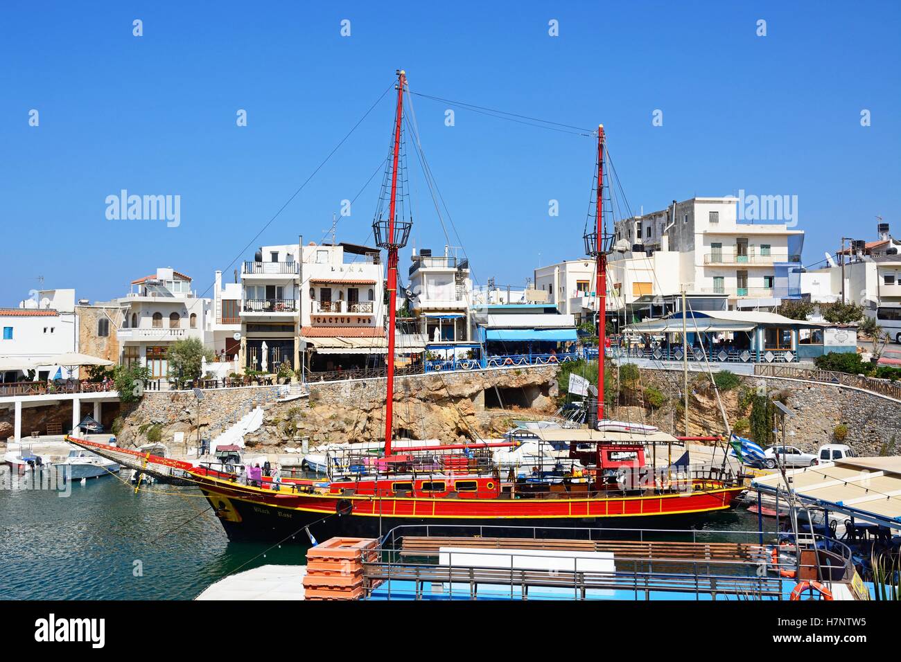 Black Rose Pirate ship moored in the harbour with waterfront ...