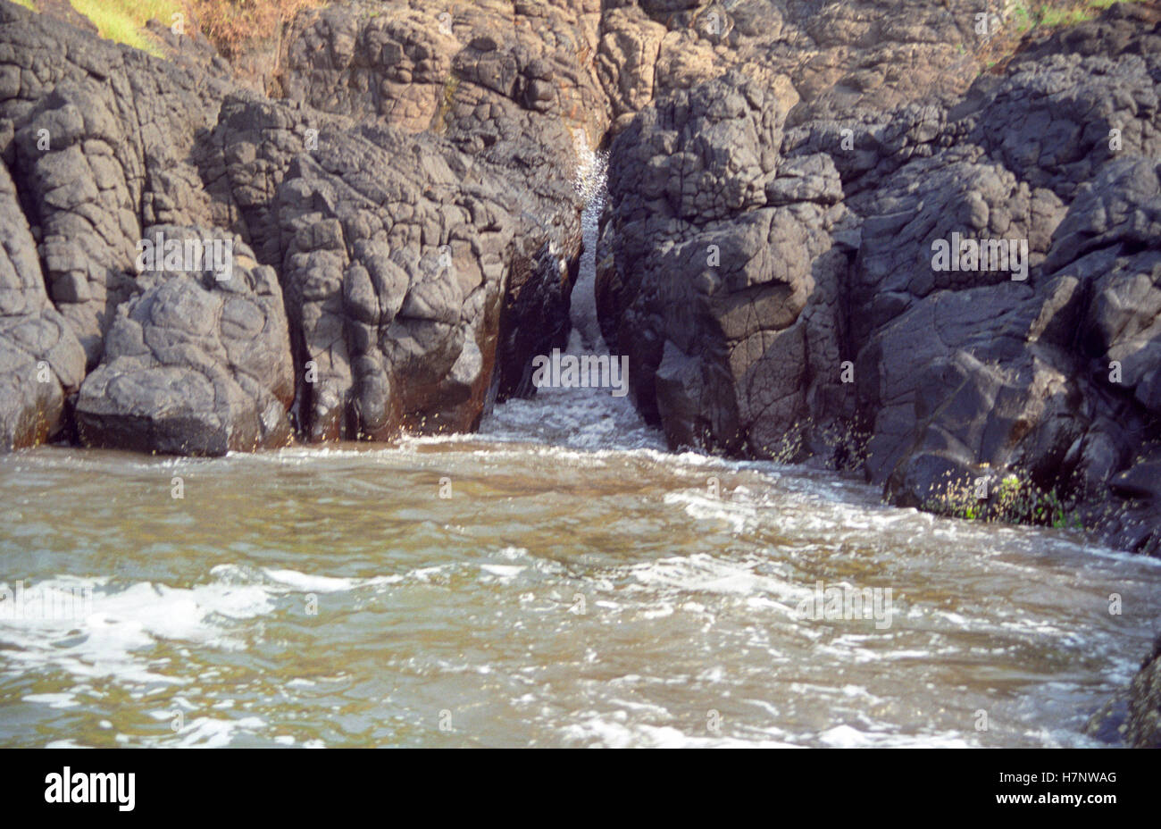 A narrow gorge called 'Baman Ghal' on rocky beach of Hedvi Village ...