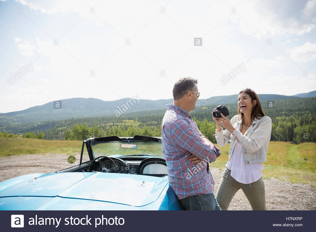 Mature couple with camera at convertible at rural overlook Stock Photo ...