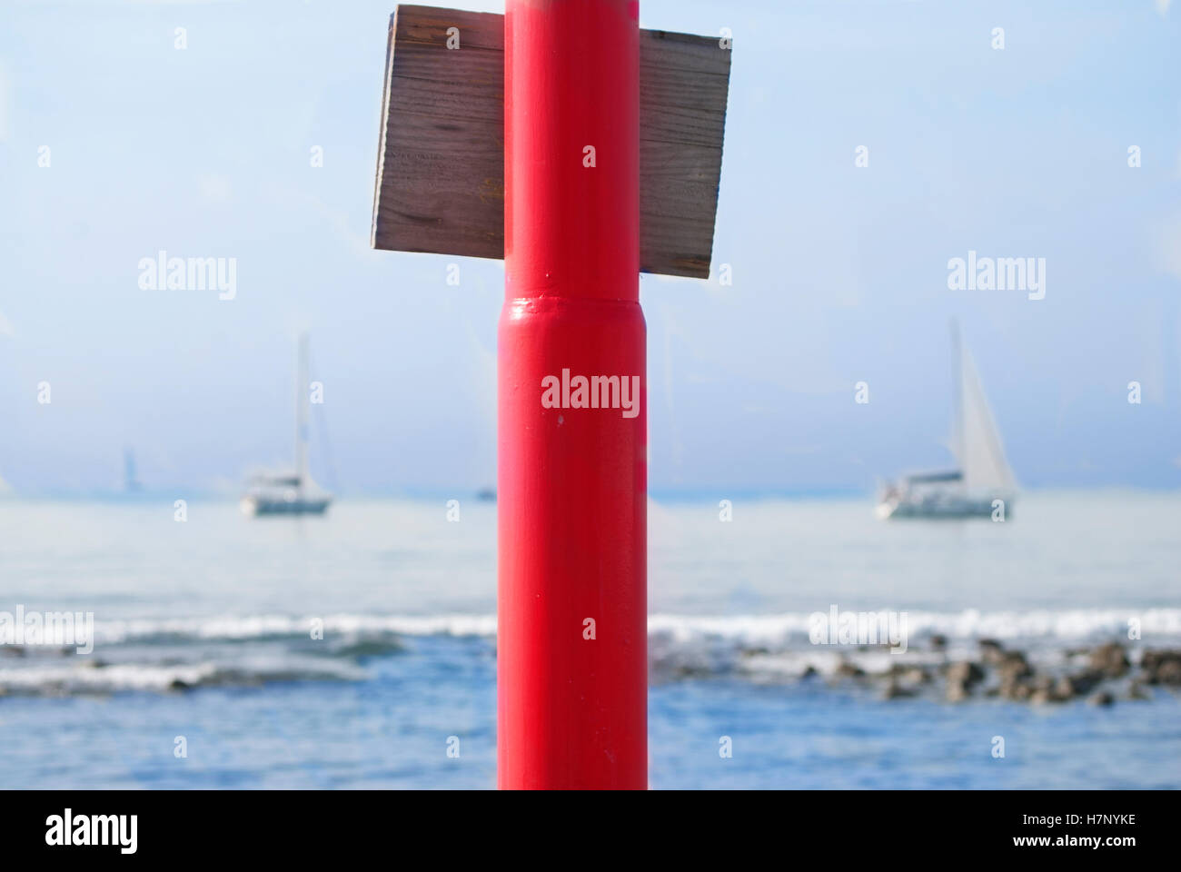 seaside with in foreground a red colored lamp-post Stock Photo - Alamy