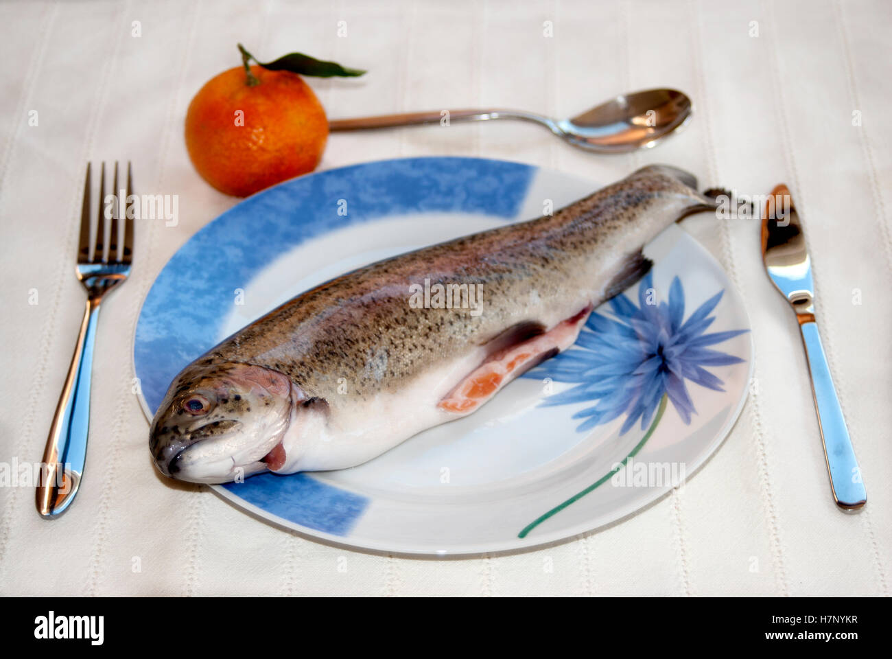 raw fresh trout in a dish on a set table Stock Photo - Alamy