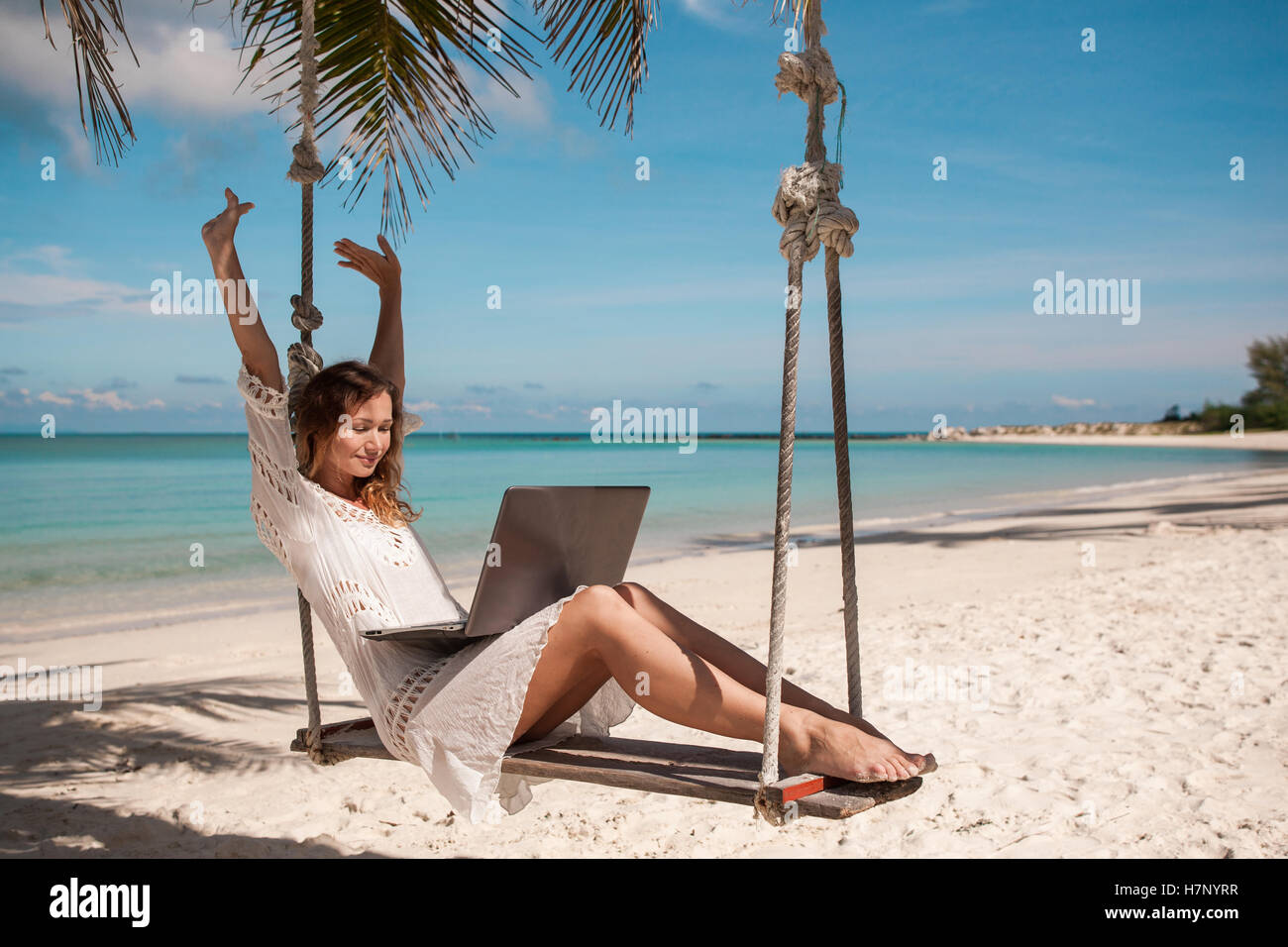 Person on laptop on beach hi-res stock photography and images - Alamy