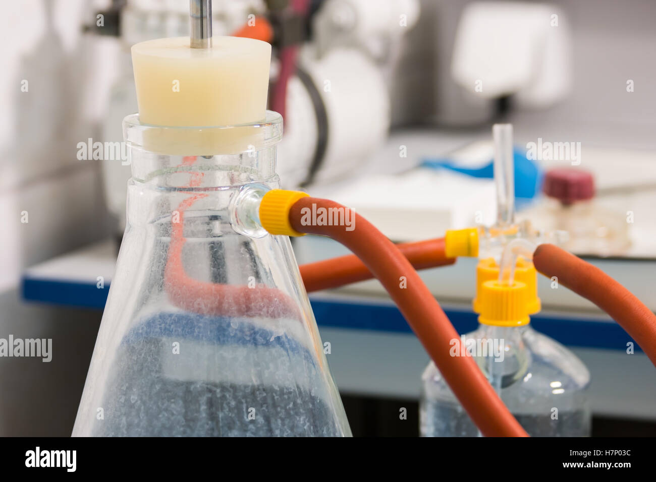 Beaker on blurred background Stock Photo - Alamy