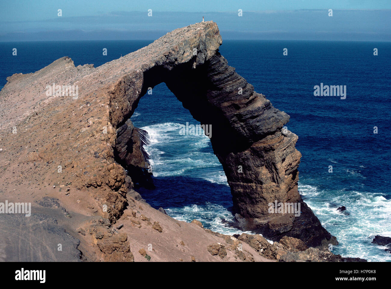 Waves seen through natural bridge in rock, Skeleton Coast, Namibia ...