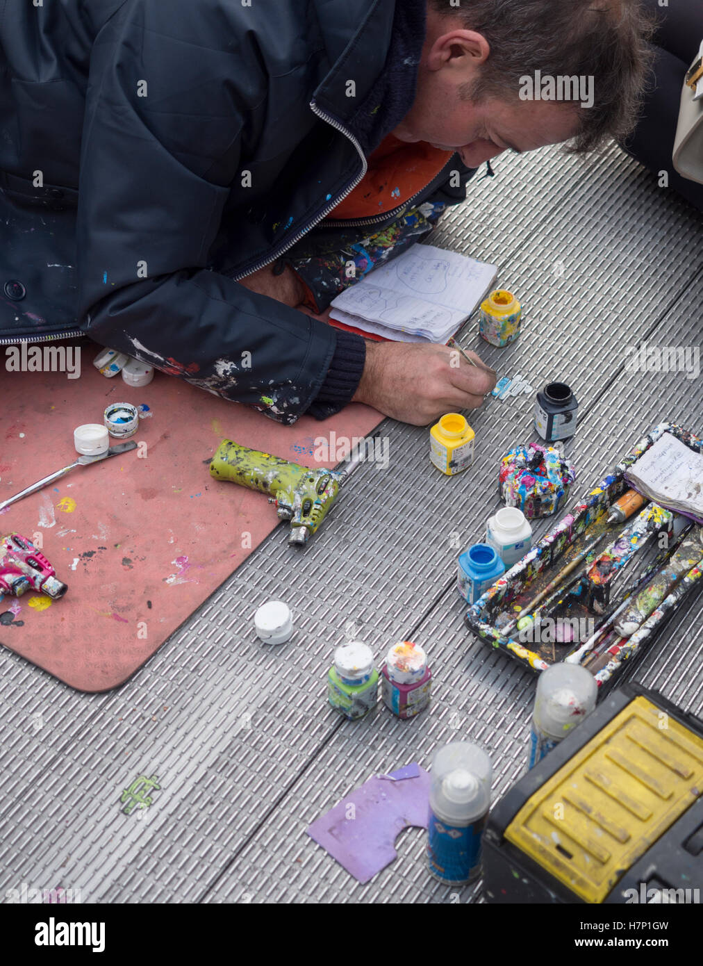 The artist Ben Wilson painting chewing gum on the Millennium Bridge in ...