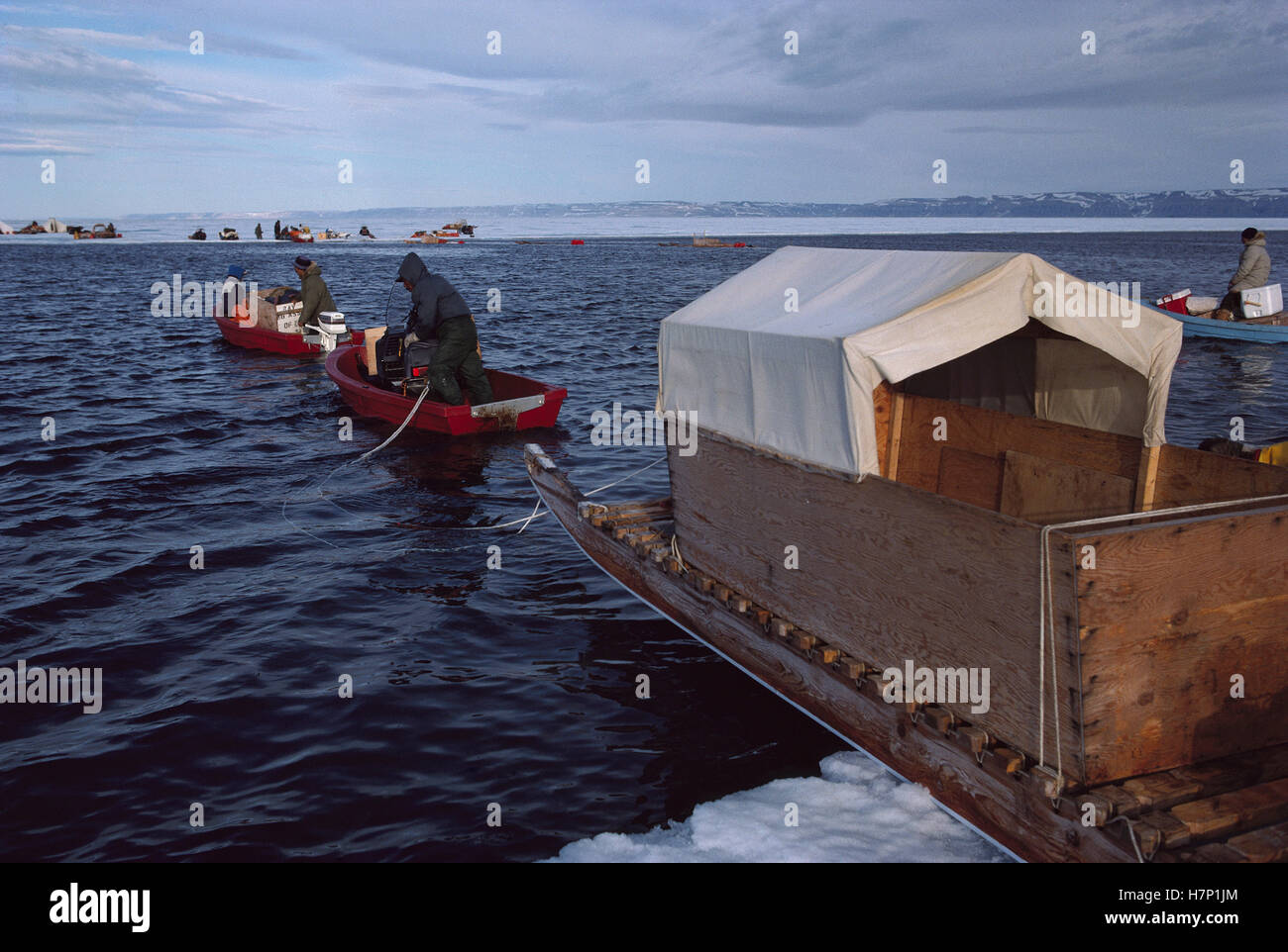 Inuit hunters crossing ice break, Admirality Inlet, Arctic Bay, Canada ...