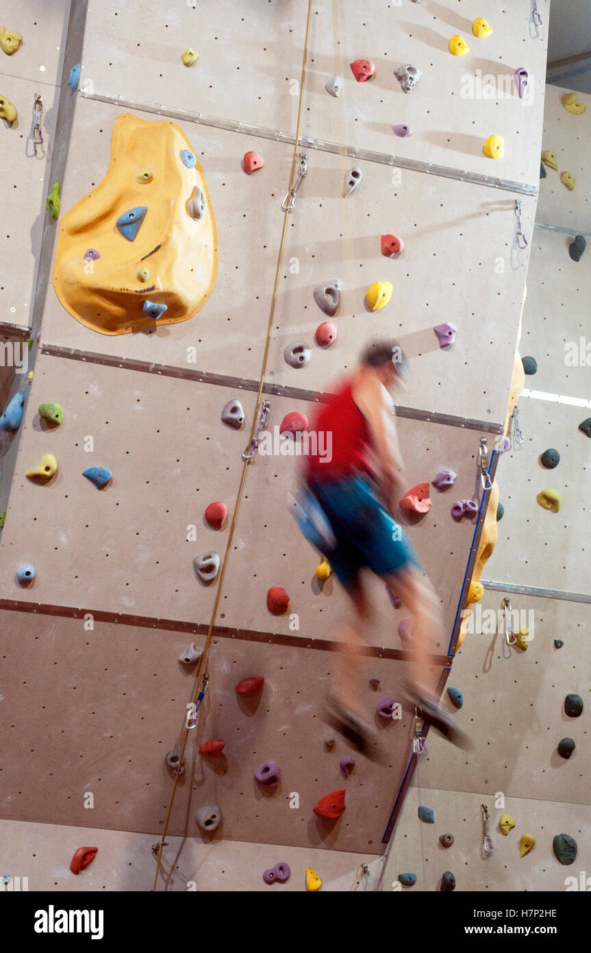 Man Climbing with Ropes on Climbing Wall Stock Photo - Alamy