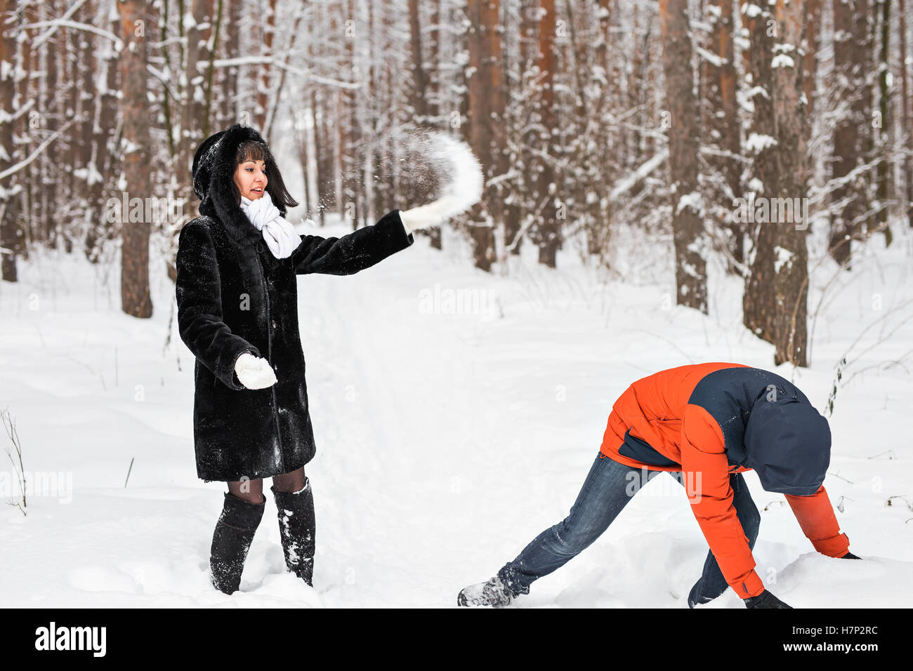 Young couple playing in snow, having snowball fight Stock Photo - Alamy