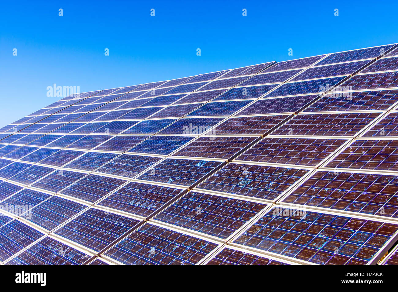 Close up of blue solar panels with blue sky, renewables Stock Photo - Alamy