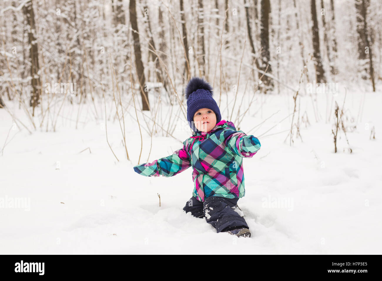 Laughing baby girl playing in the snow Stock Photo - Alamy