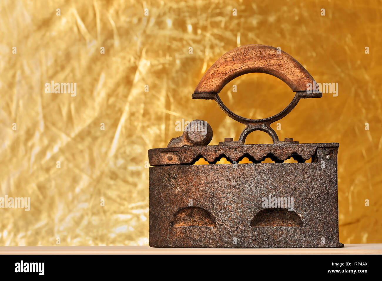 Big old metal iron on a warm background Stock Photo - Alamy
