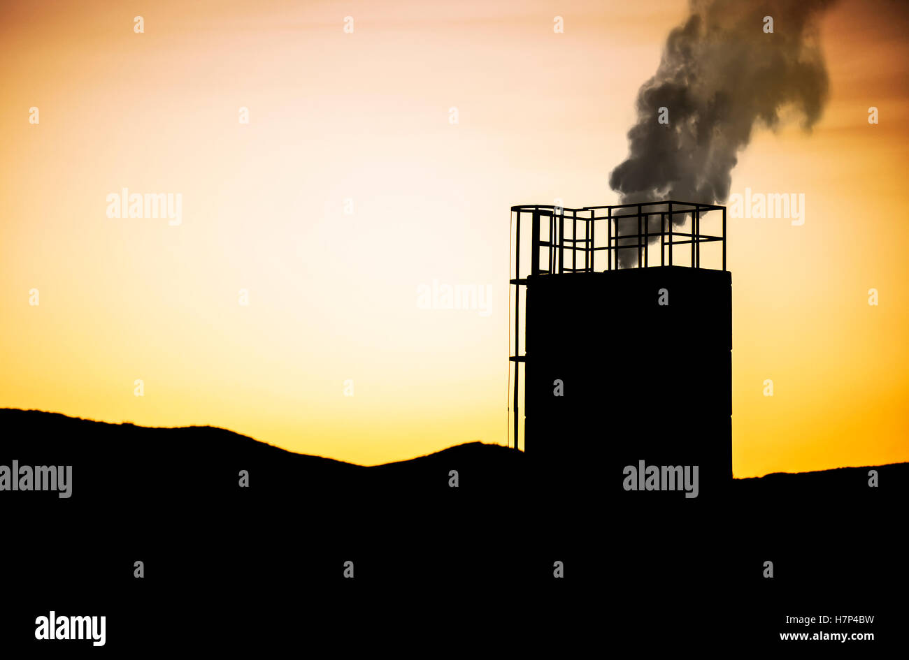 Industrial chimney in sunset with smoke Stock Photo - Alamy