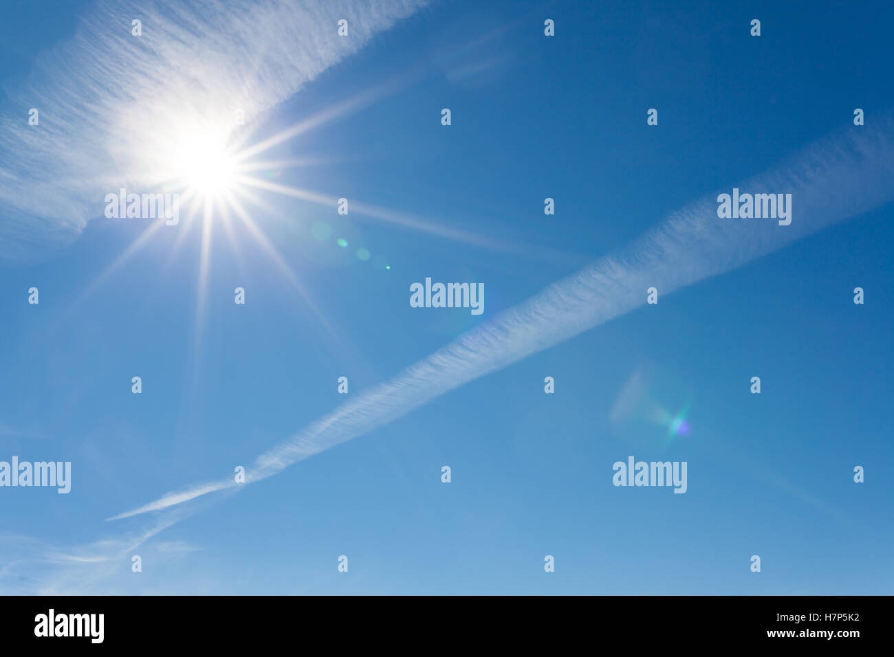 Sun shining blue sky Stock Photo - Alamy