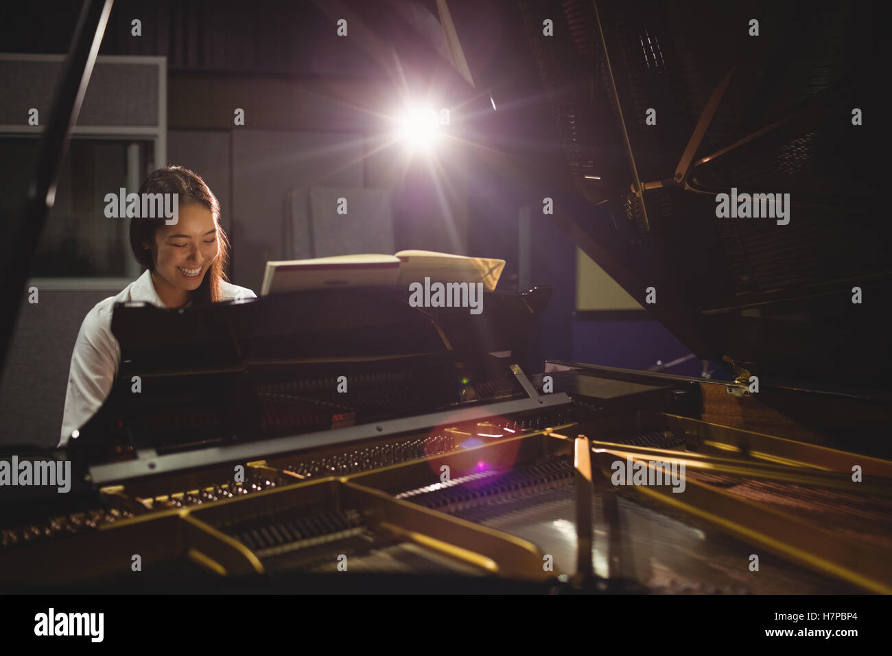 Female student playing piano Stock Photo - Alamy