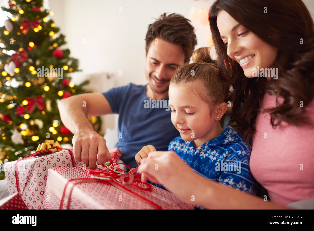 Opening Christmas present with parents Stock Photo - Alamy