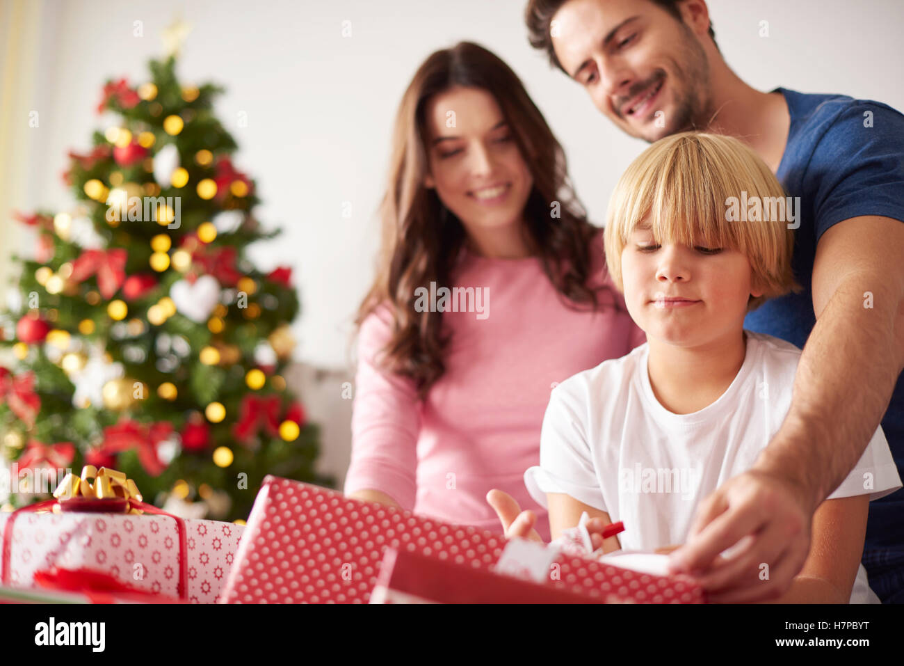 Family starting Christmas from opening presents Stock Photo - Alamy