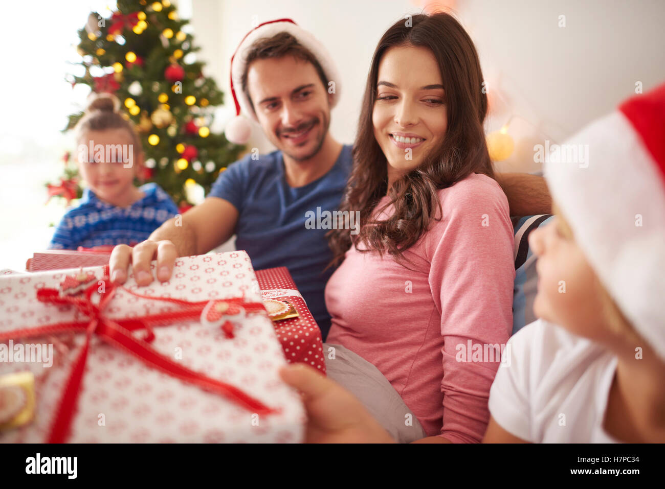 Family during the Christmas morning with presents Stock Photo - Alamy