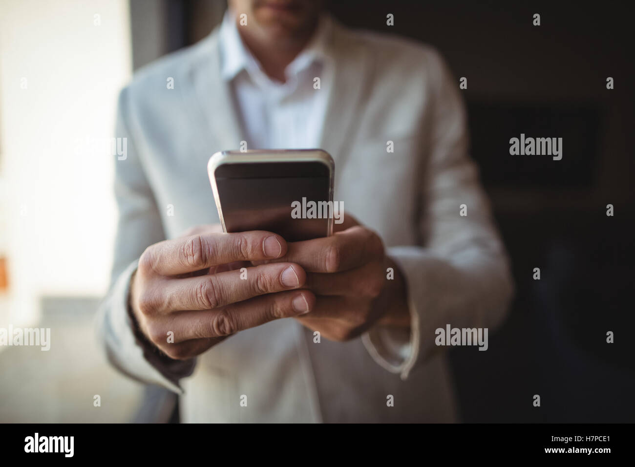 Business man using his mobile phone Stock Photo - Alamy