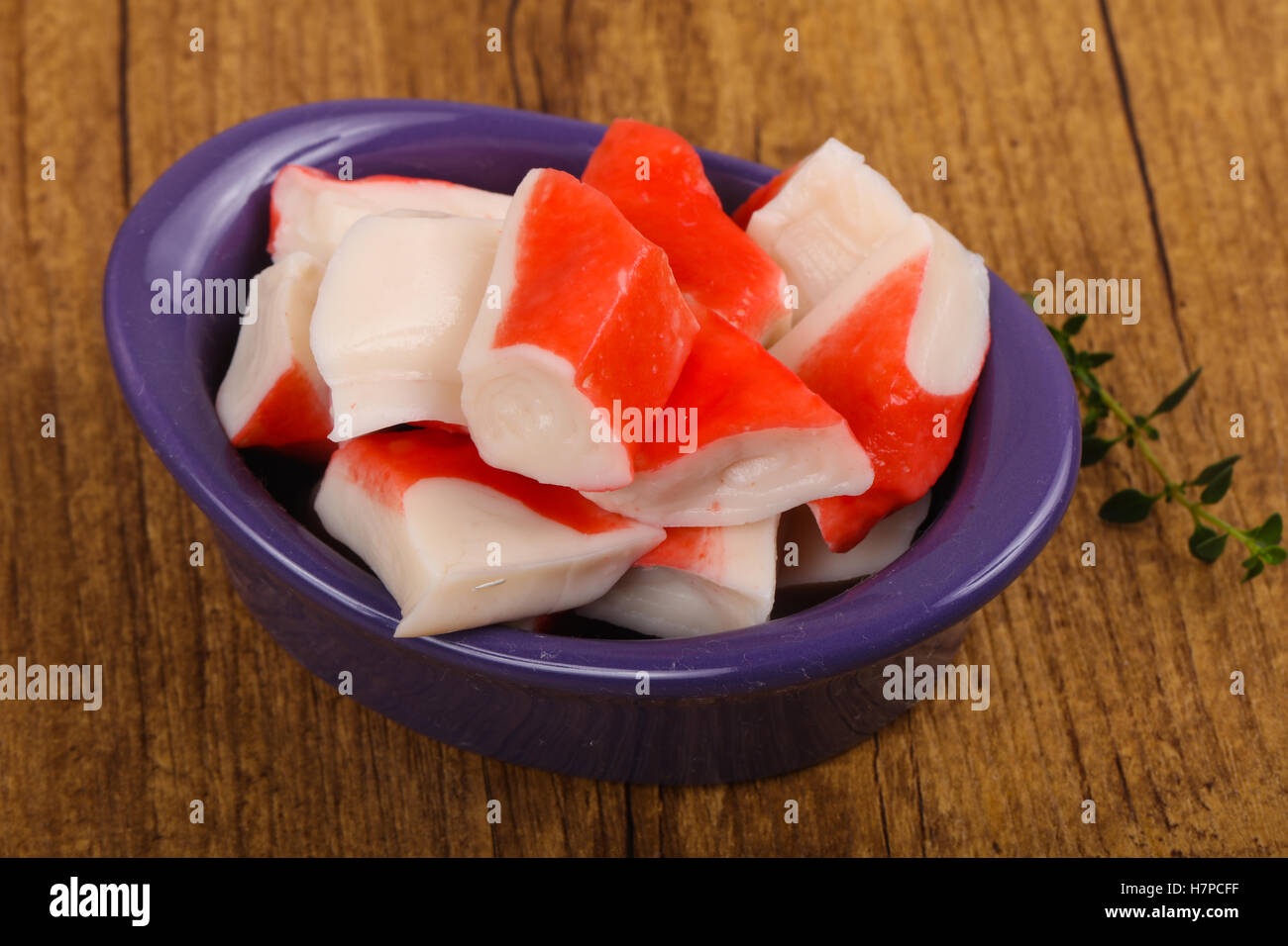 Crab stick - surimi in the plate - over wood background Stock Photo - Alamy