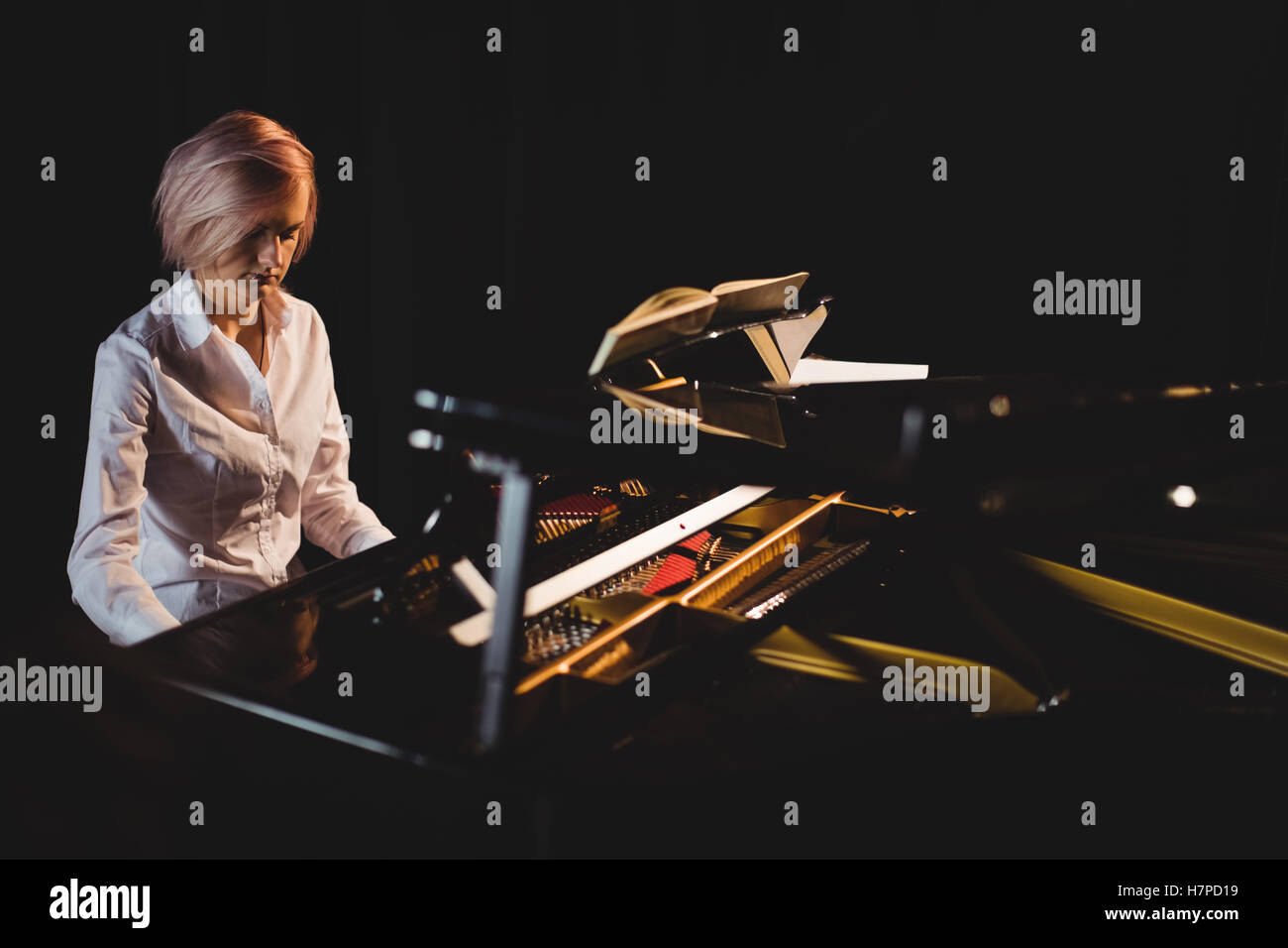 Female student playing piano Stock Photo - Alamy