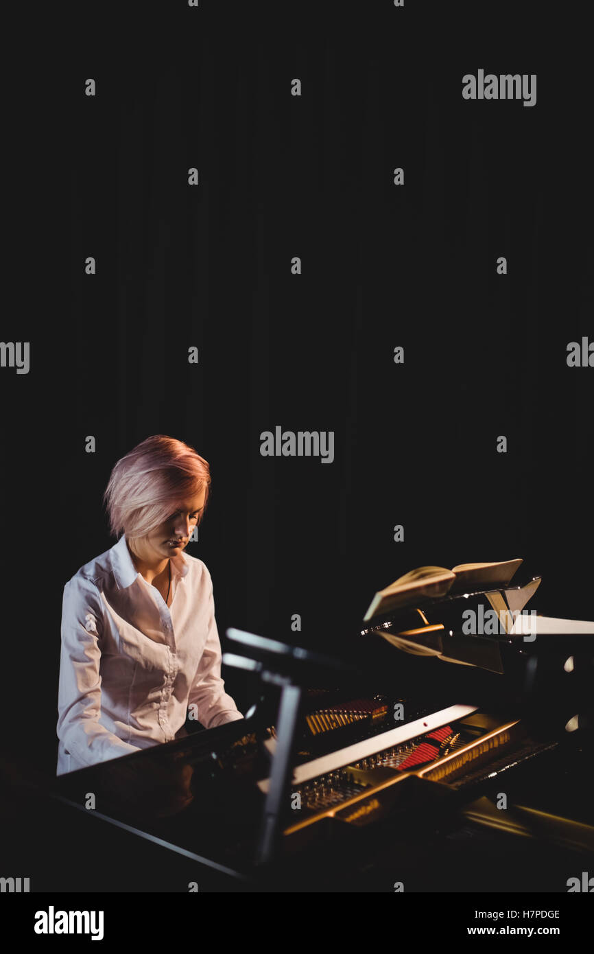 Female student playing piano Stock Photo - Alamy