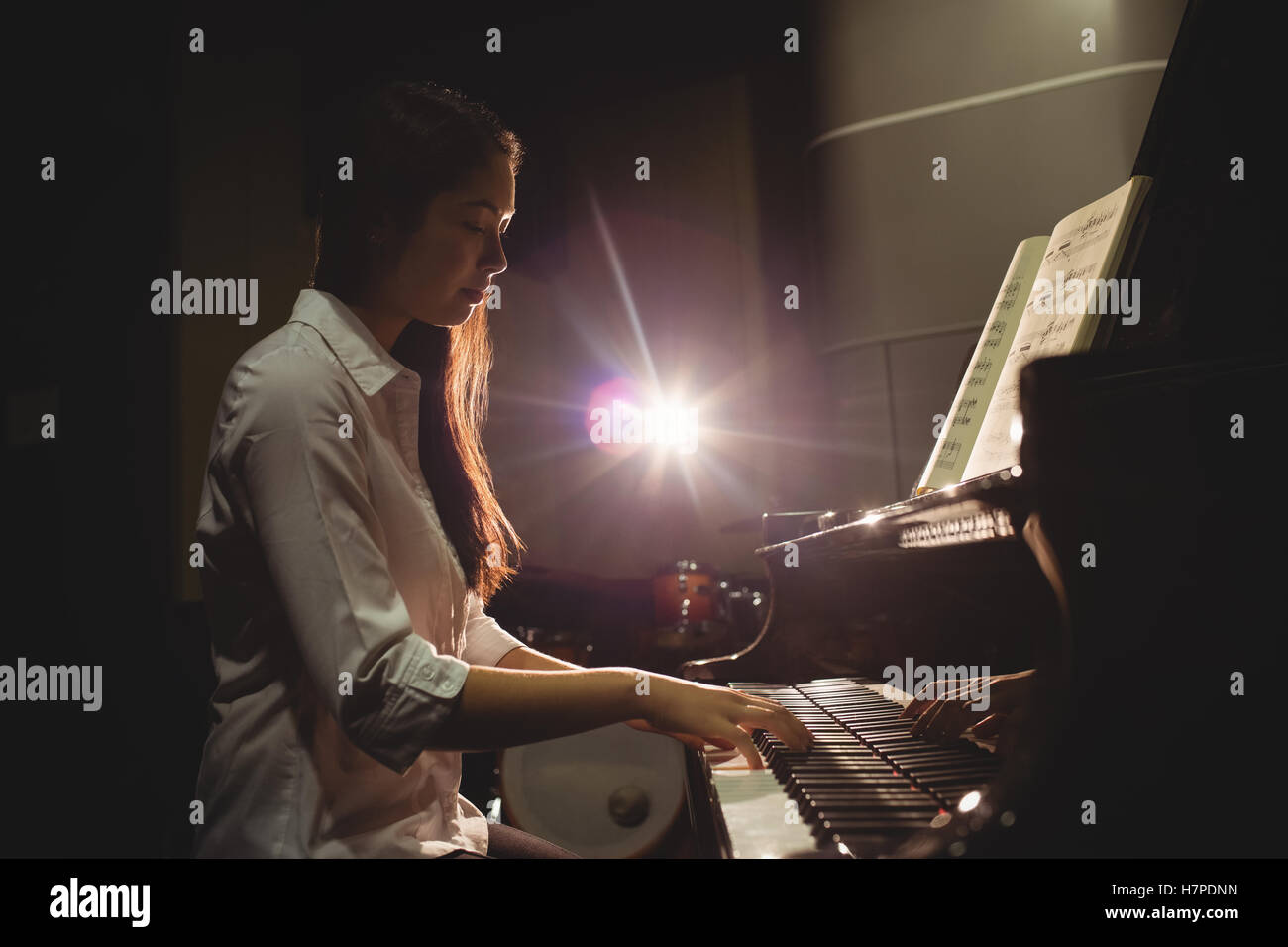 Female student playing piano Stock Photo - Alamy