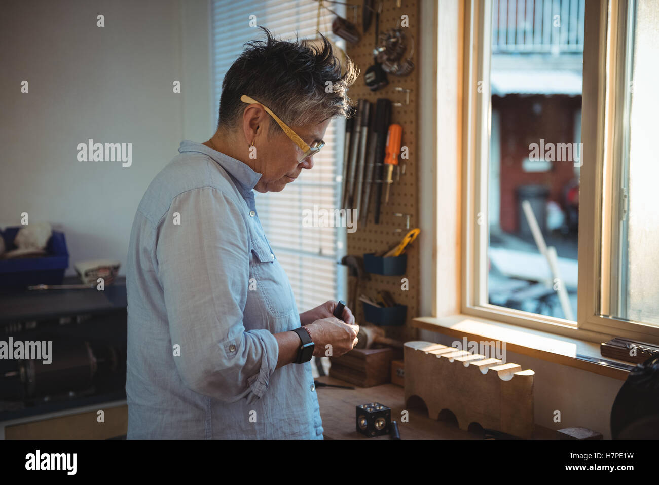Craftswoman working in workshop Stock Photo - Alamy