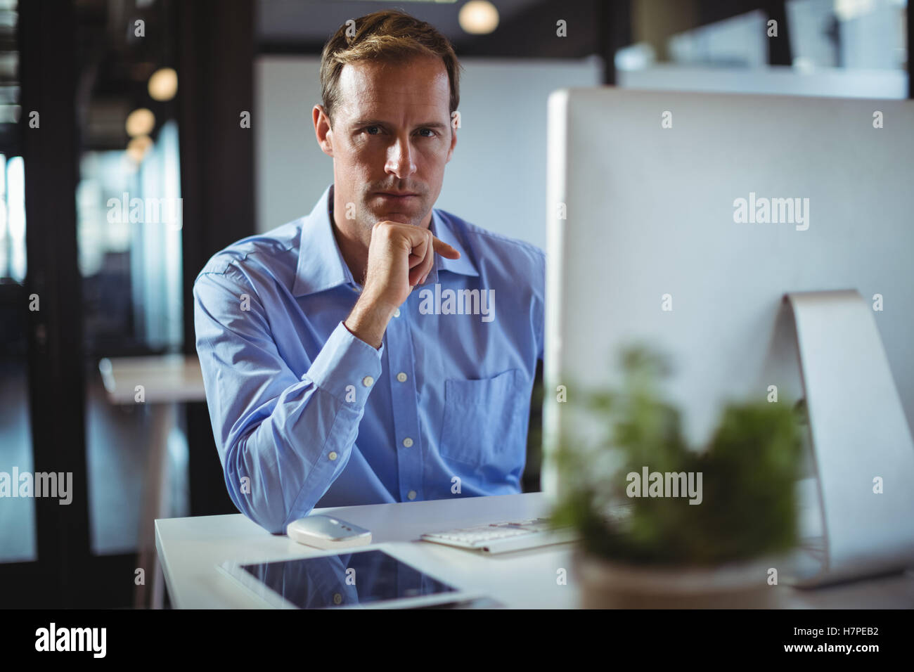 Businessman using desktop pc in office Stock Photo - Alamy