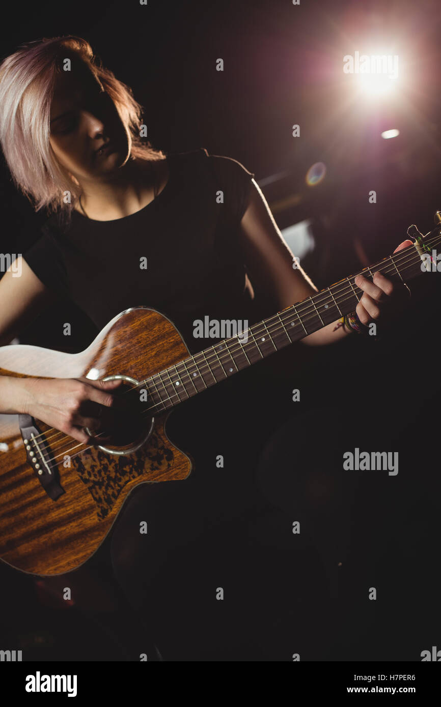 Female student playing guitar Stock Photo - Alamy