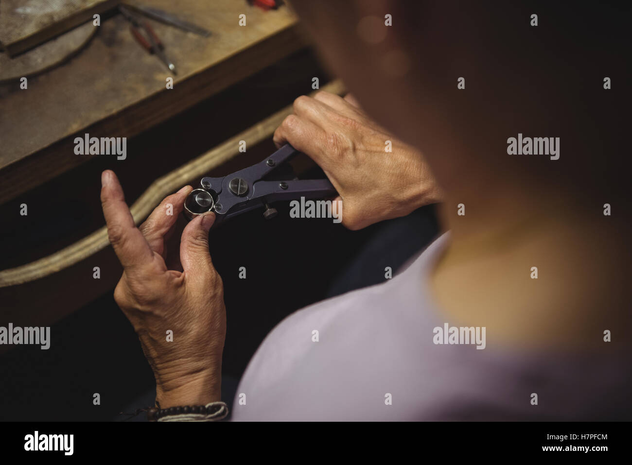 Hands of craftswoman using pliers Stock Photo - Alamy