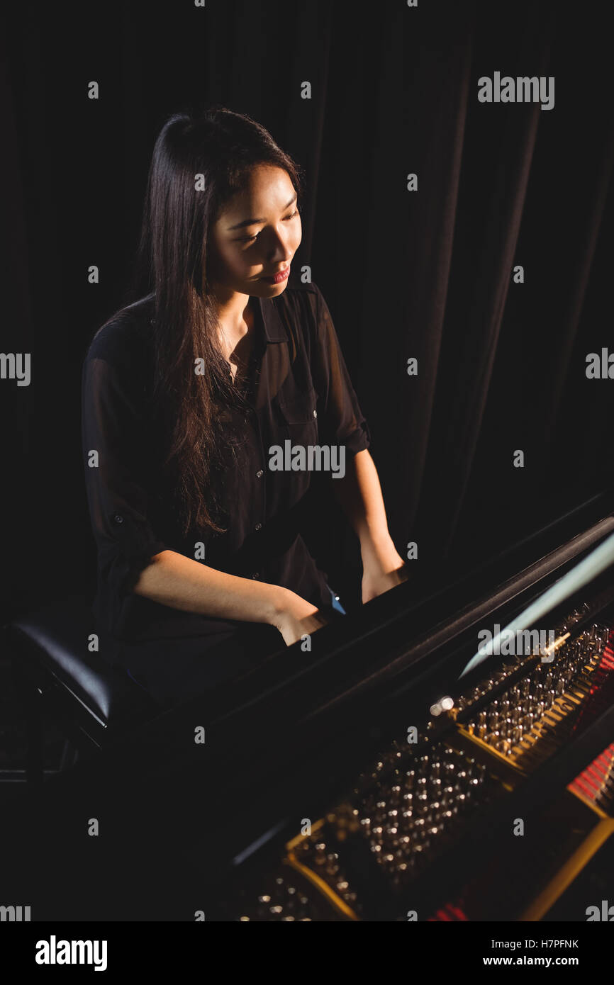 Woman playing a piano in music studio Stock Photo - Alamy