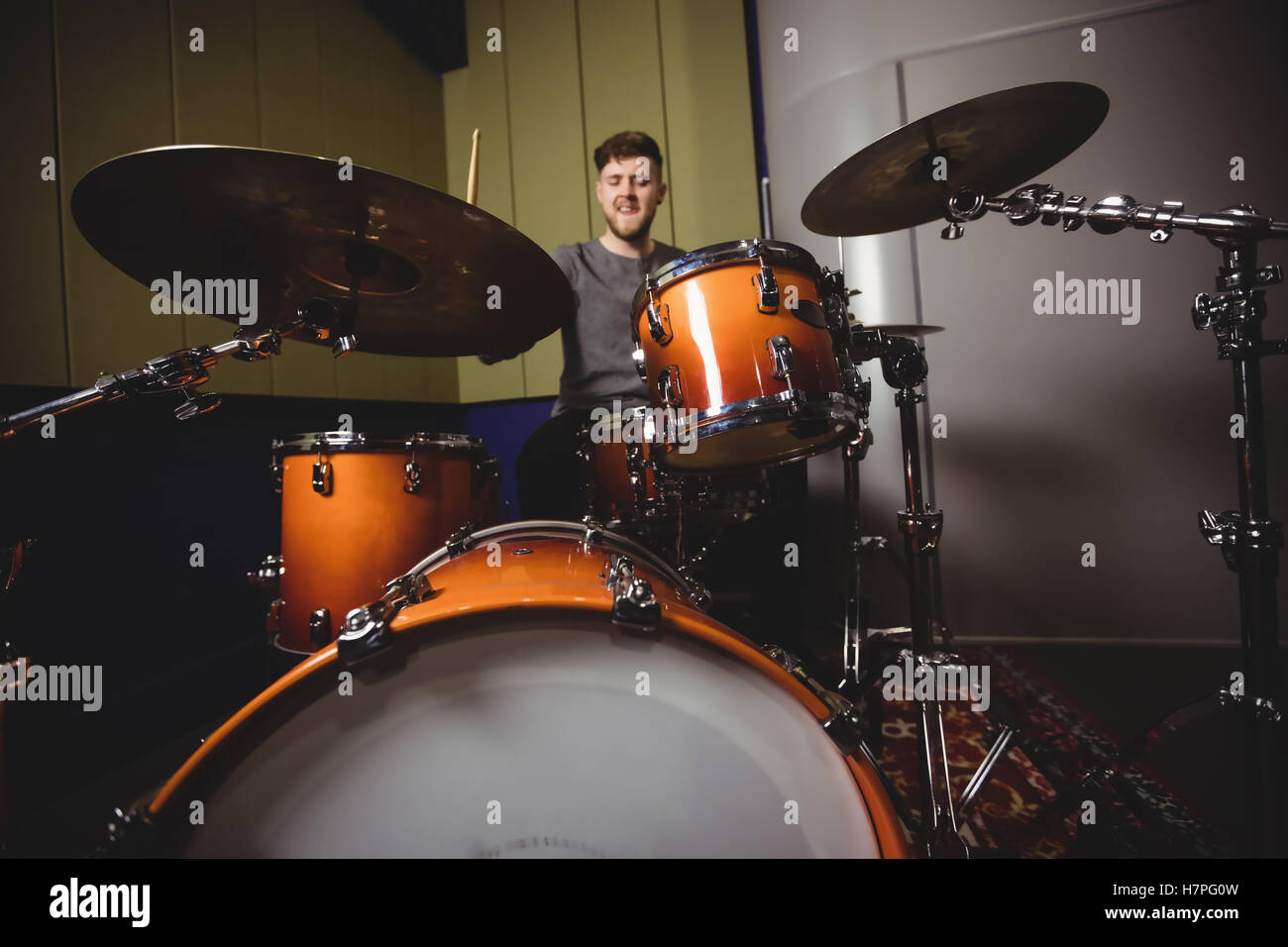 Male student playing drum set Stock Photo - Alamy
