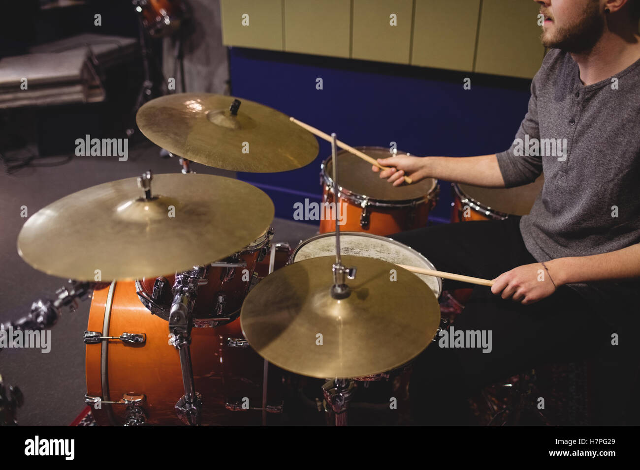 Male student playing drum set Stock Photo - Alamy