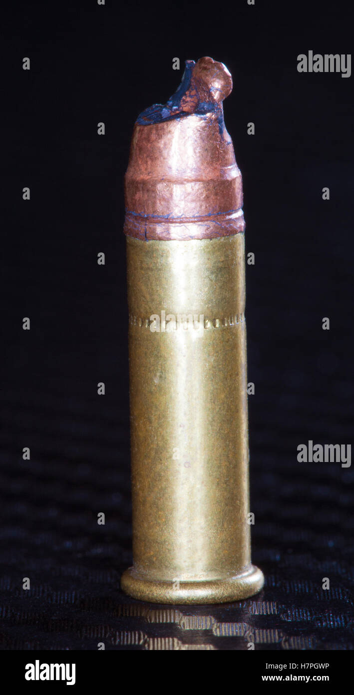 Bent bullet on top of a rimfire cartridge caused by a stovepipe in a ...