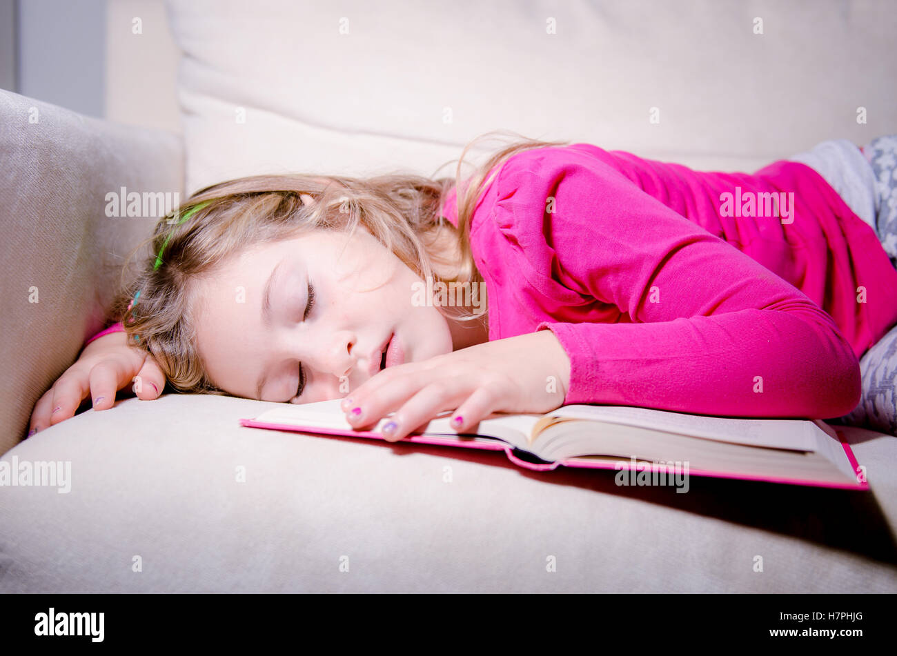 little girl asleep on the book Stock Photo - Alamy