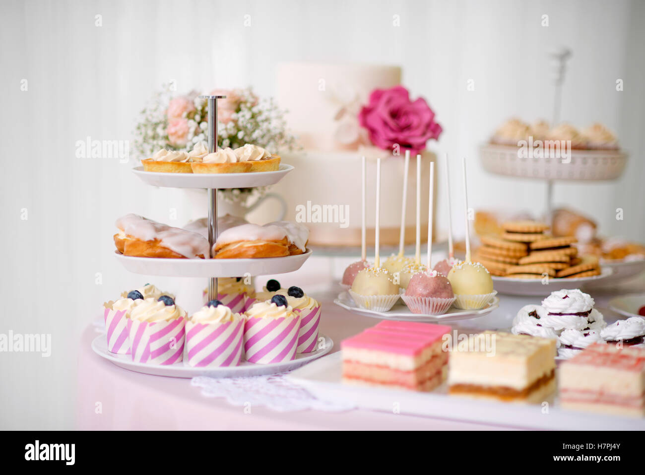 Table with loads of cakes, cupcakes, cookies and cakepops Stock Photo ...